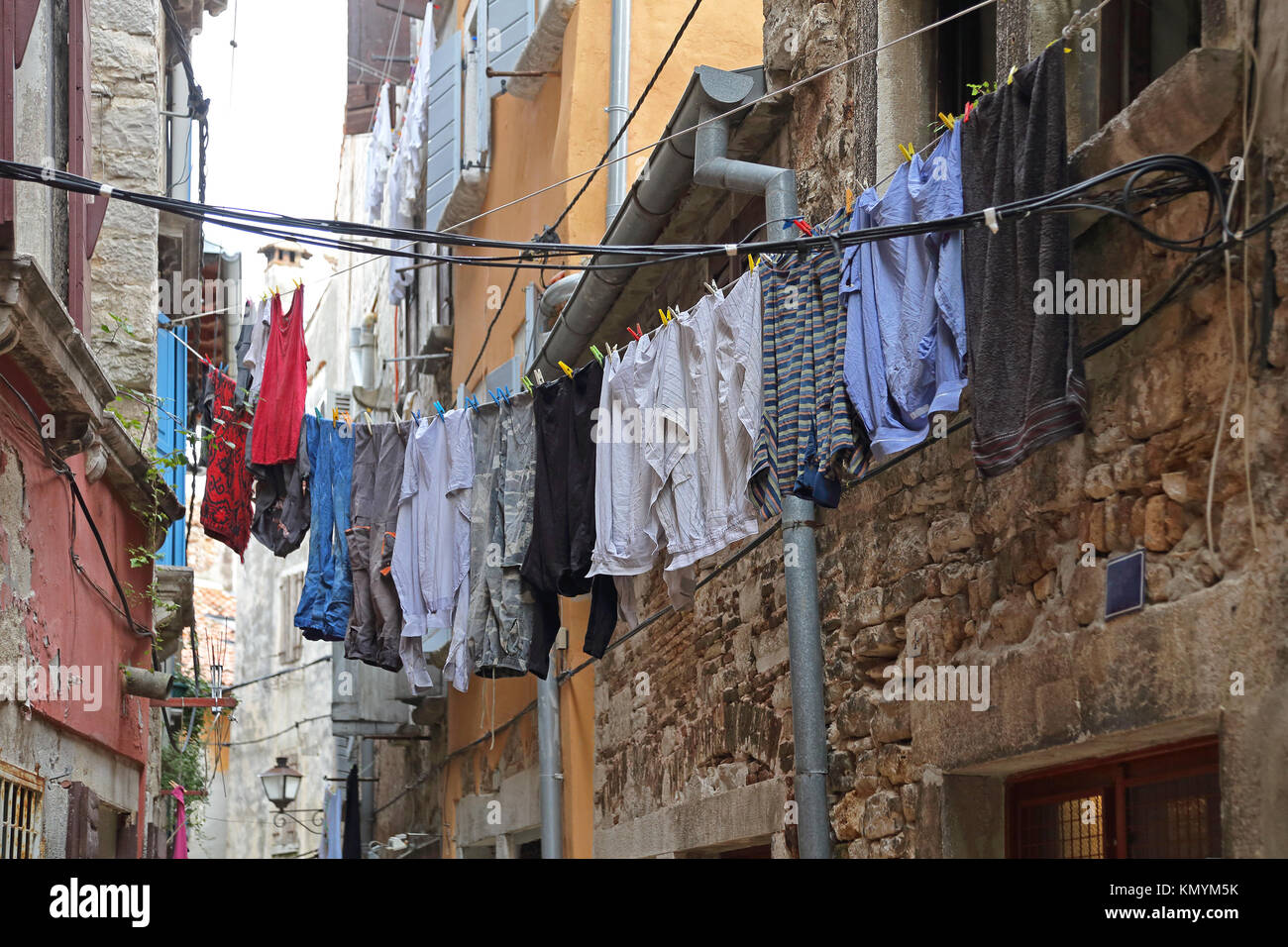 Clothes Line Between Old Houses in Narrow Street Stock Photo - Alamy