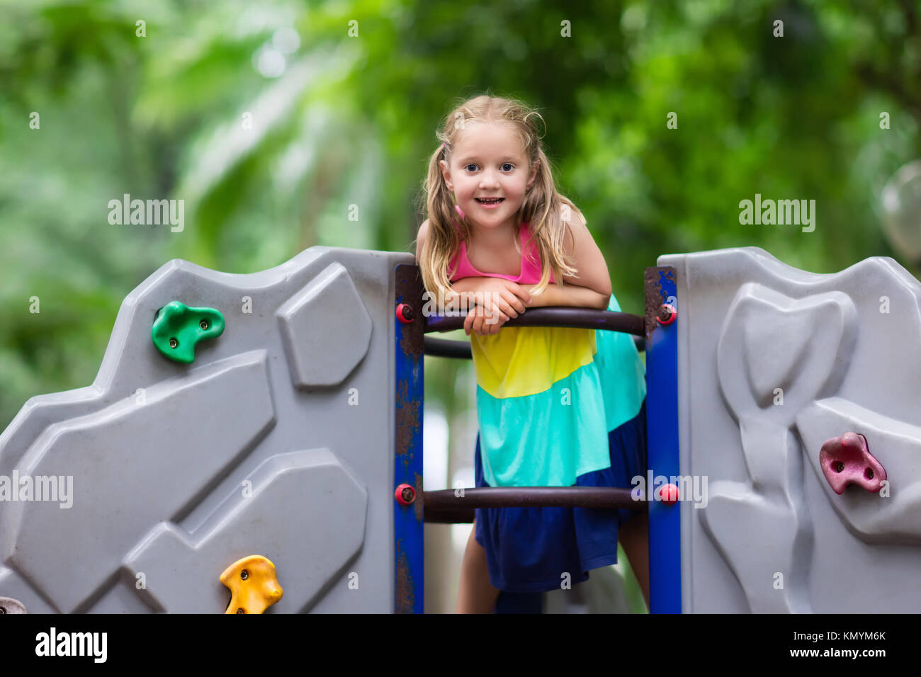Kids on playground. Children play in summer park. Child on slide and ...