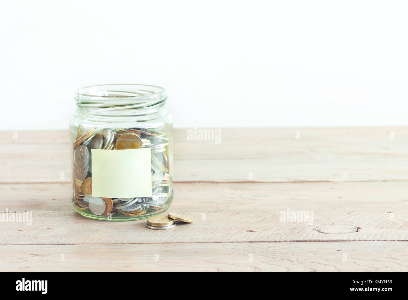 Coins in glass jar with empty label. Money savings concept. Jar with ...