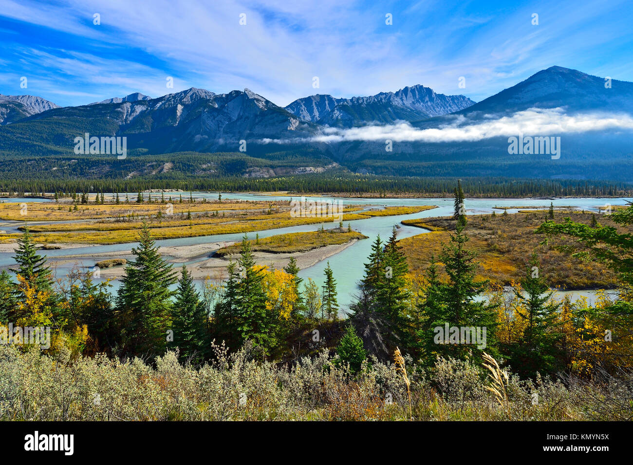 A fall landscape image of the Athabasca river winding through Jasper ...