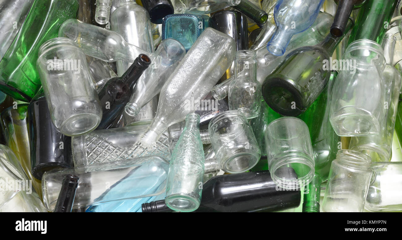 Glass bottles inside a glass recycling container Stock Photo - Alamy