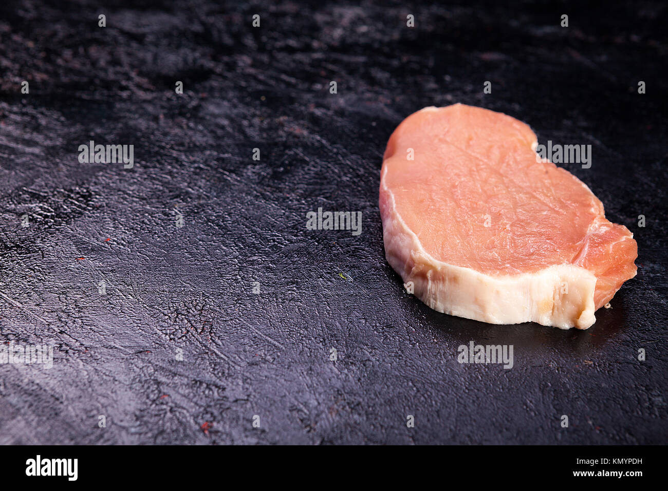 Top view of fresh raw meat on on black wooden table Stock Photo - Alamy