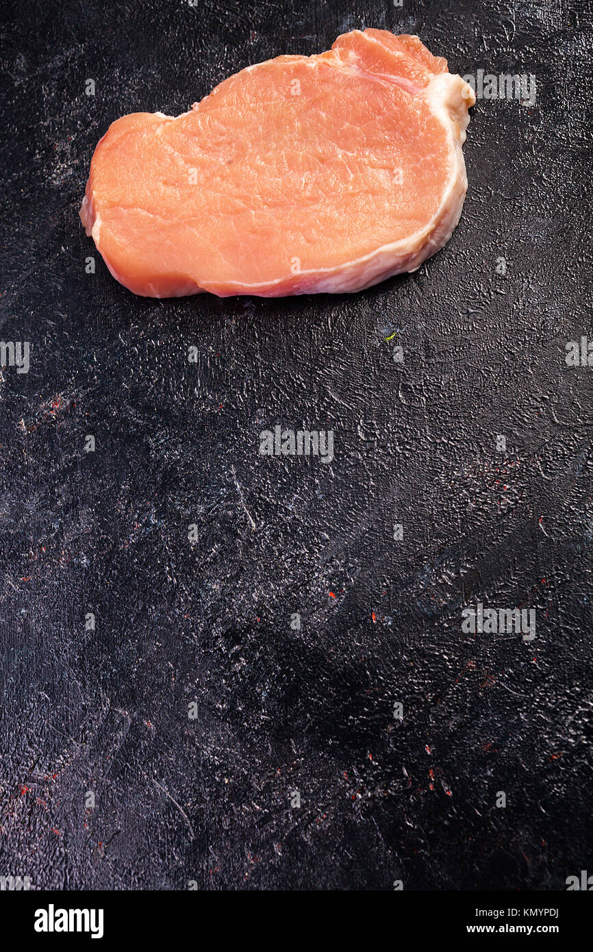 Top view of fresh raw meat on on black wooden table Stock Photo - Alamy