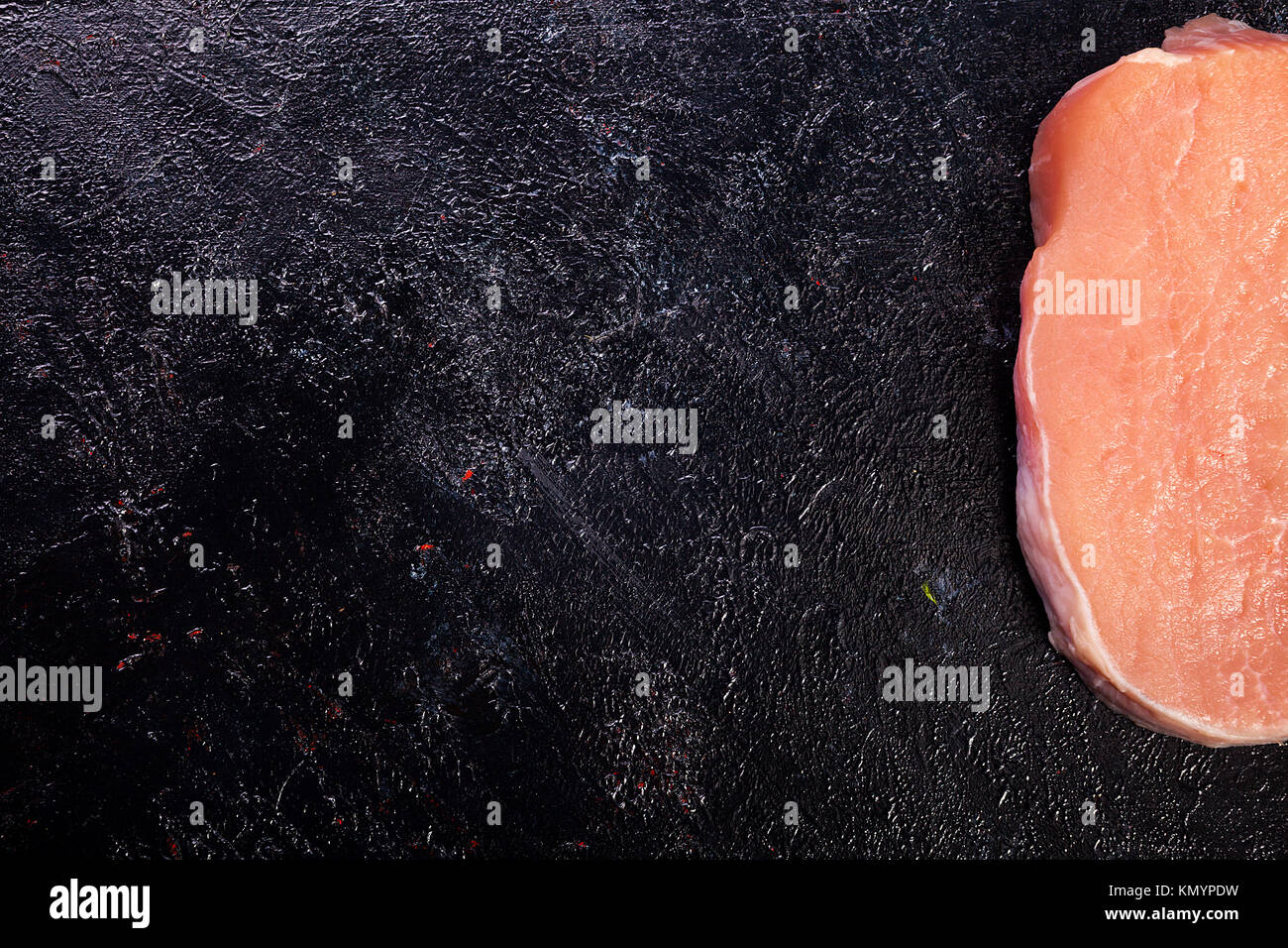 Top view of fresh raw meat on on black wooden table Stock Photo - Alamy