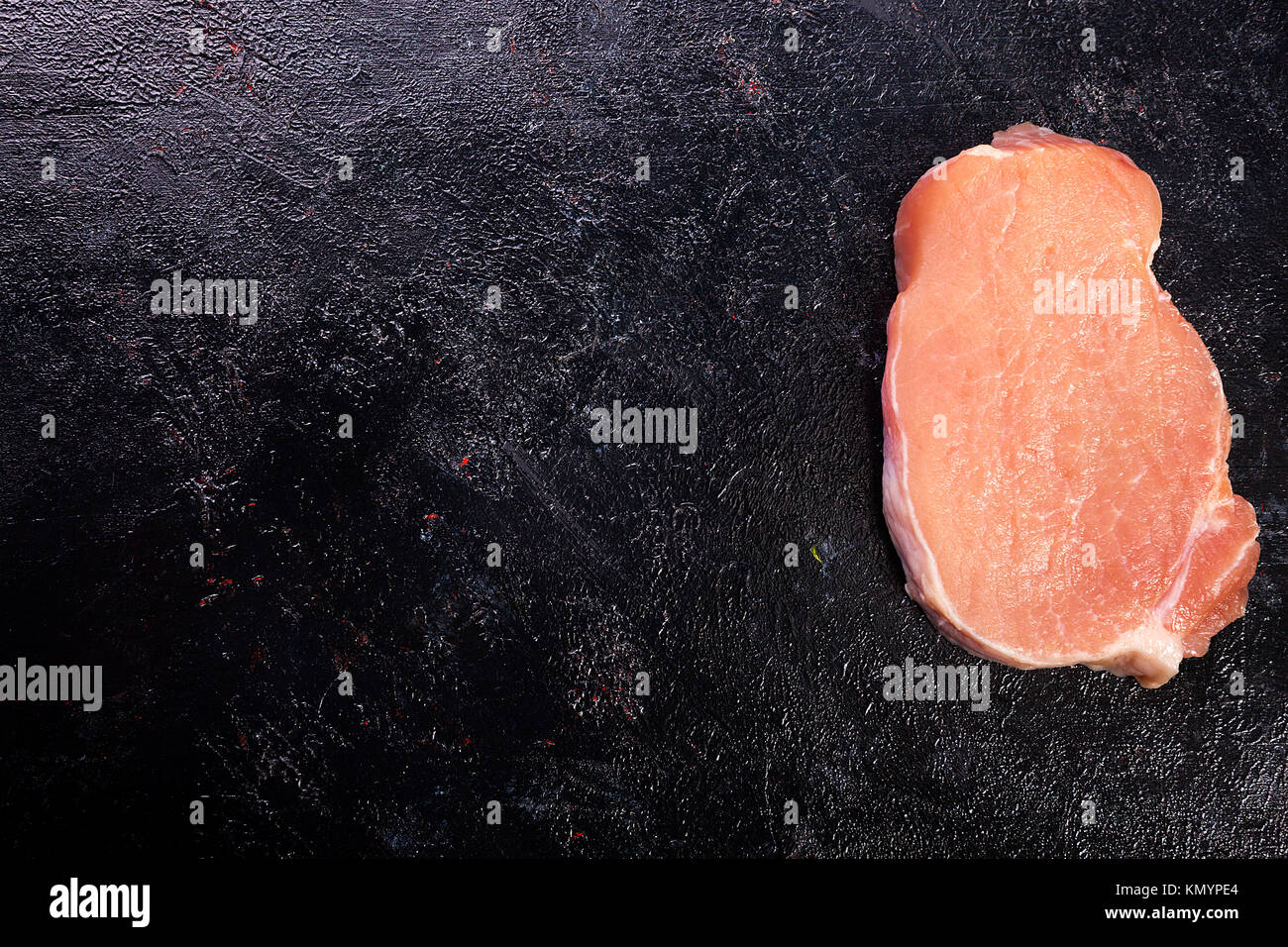Top view of fresh raw meat on on black wooden table Stock Photo - Alamy
