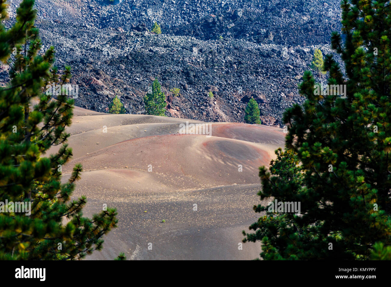 colorful lava beds and cinder cones left by volcano make bleak ...