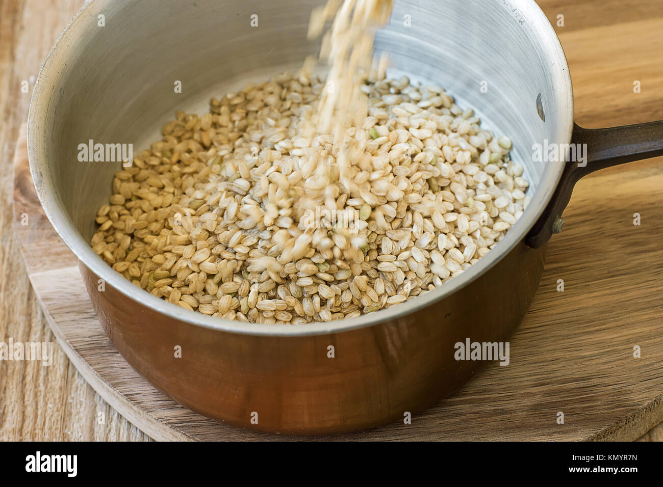 Pouring Whole Grain Brown Rice into Copper Pot Wood Table Motion Rustic ...
