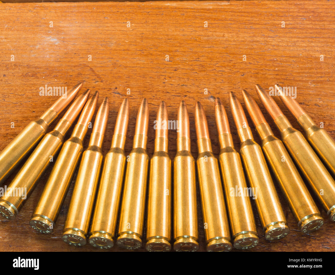 Many bullet on the wood. bullets of various calibers Stock Photo - Alamy