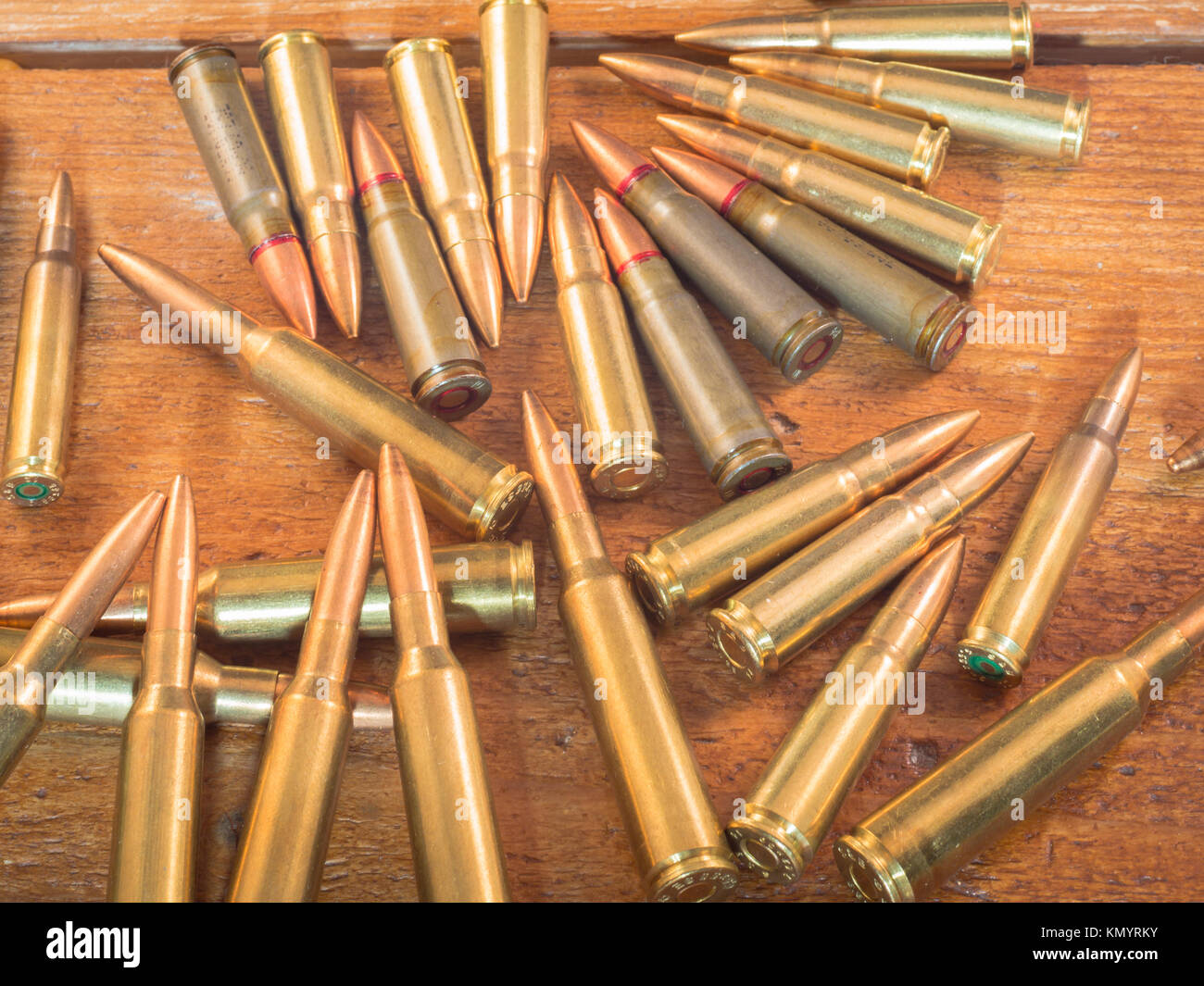 Many bullet on the wood. bullets of various calibers Stock Photo - Alamy