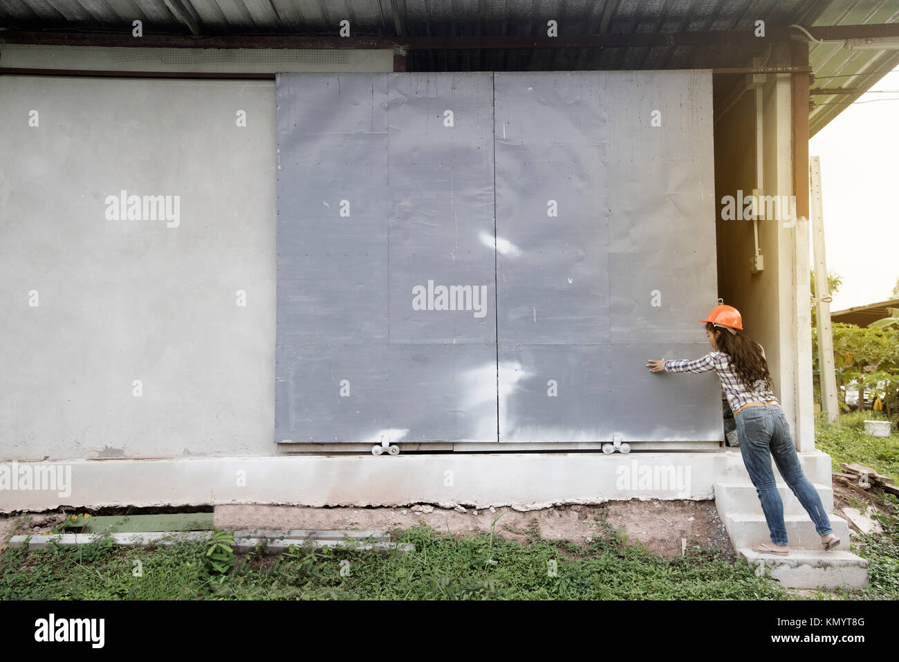 Pretty Asian carpenter woman closed large wood shop door Stock Photo ...