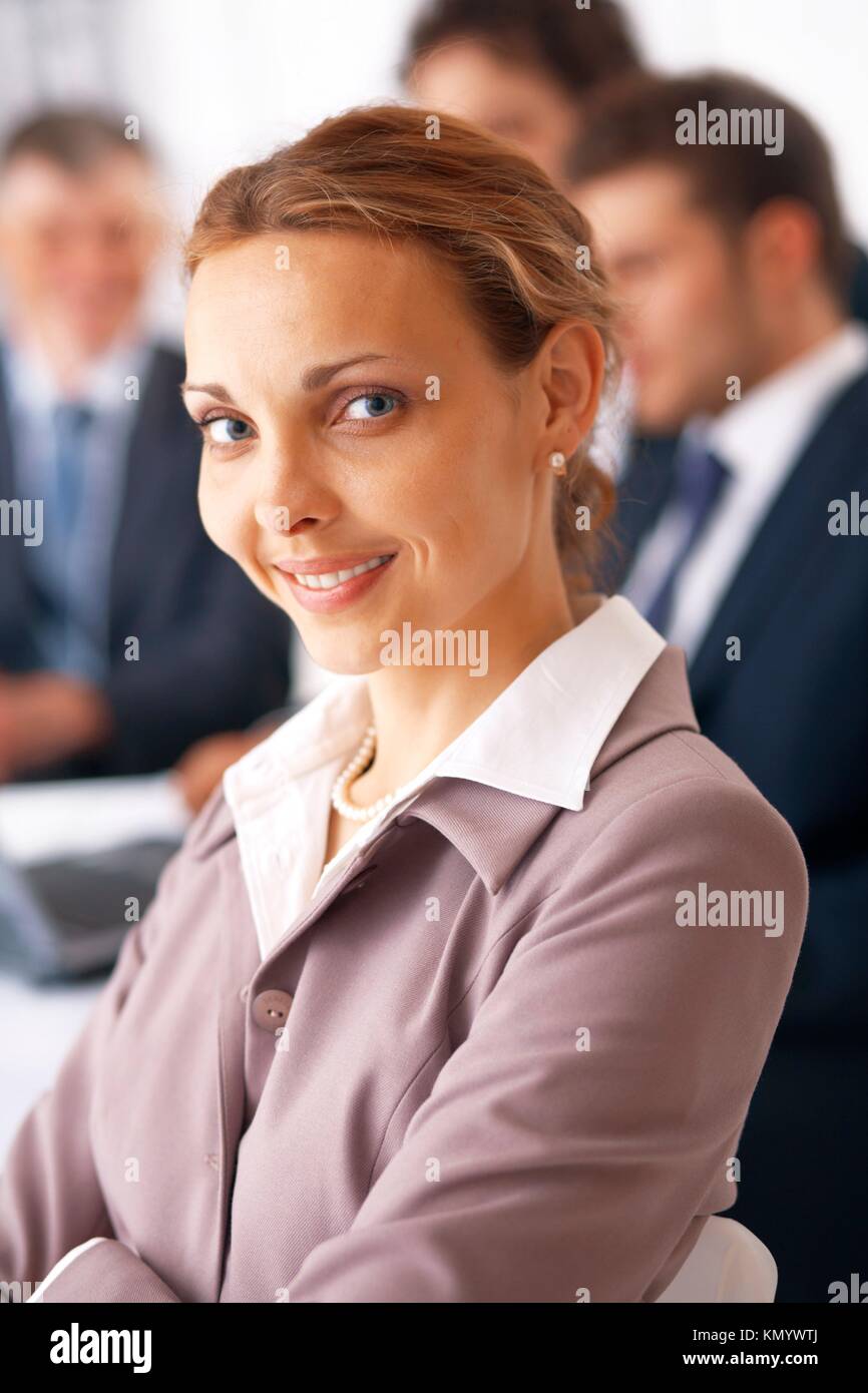 Portrait Of Young Business Woman With Folded Hands In Front Of Her