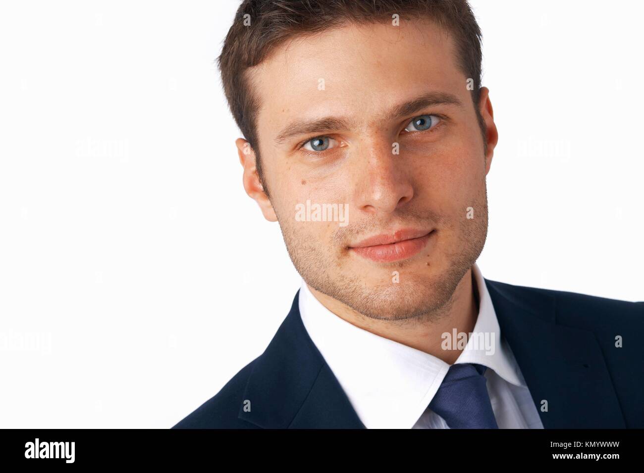Closeup portrait of a young smiling businessman over white background ...