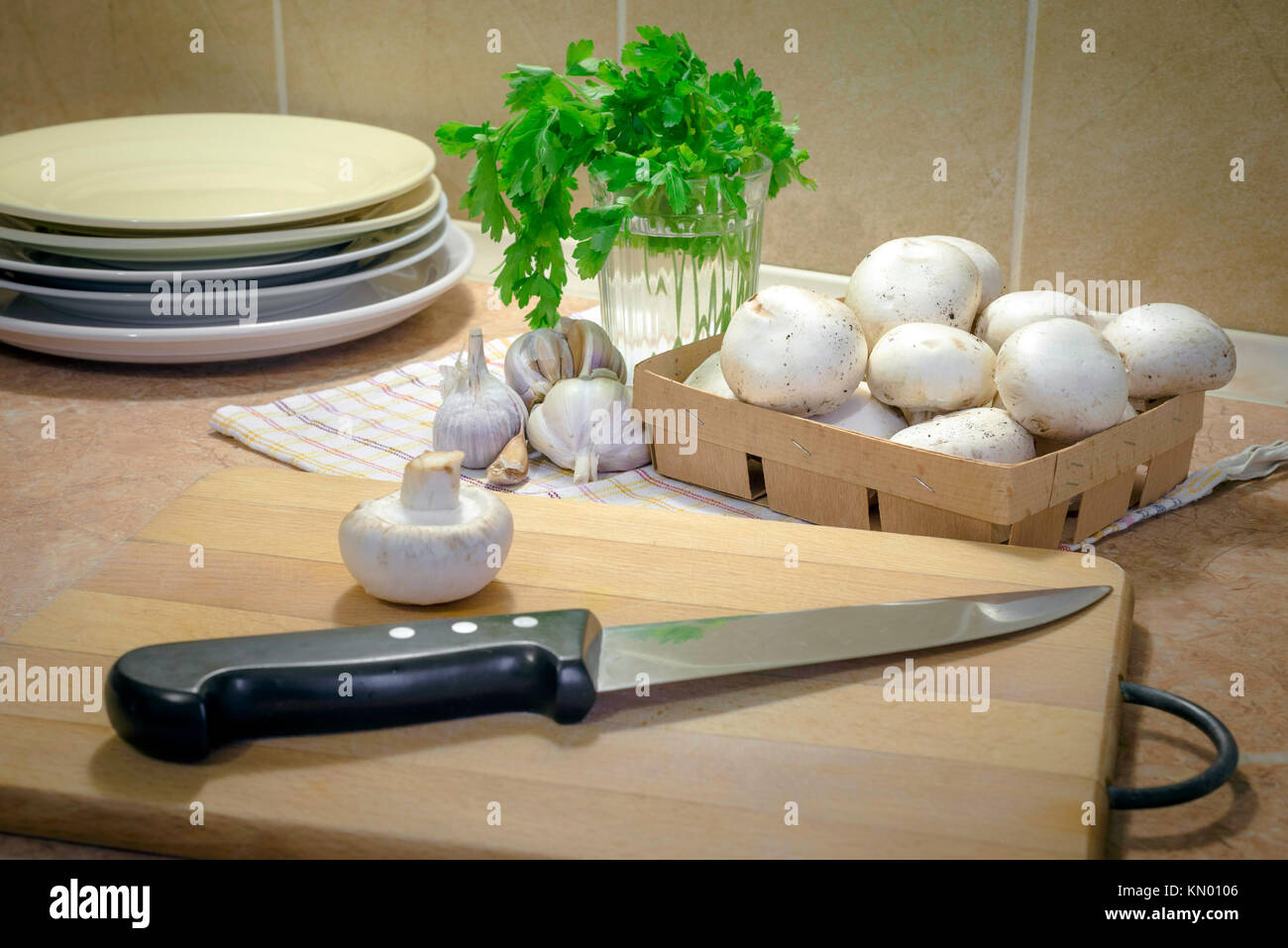Preparation of "funghi trifolati" (thinly sliced champignons cooked ...