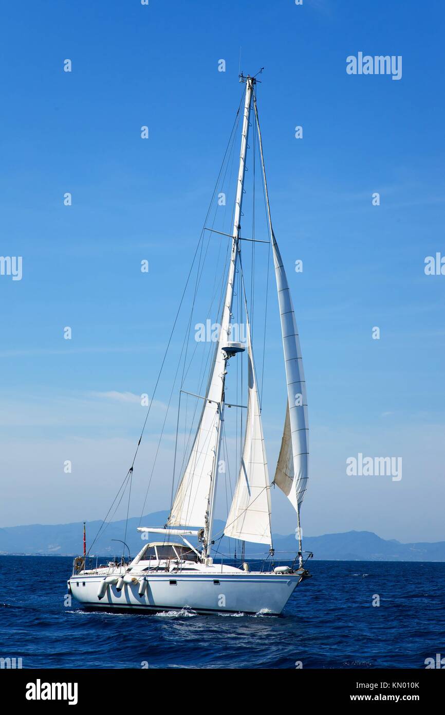 Blue Mediterranean sailboat sailing in perfect ocean Stock Photo - Alamy