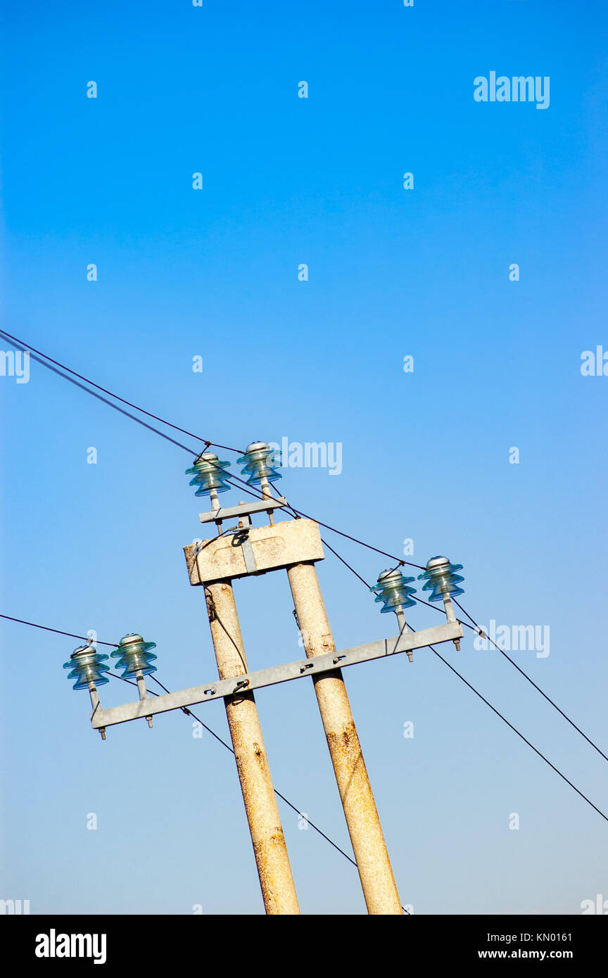 Electric power line with the wires set on isolators on a high pylon ...