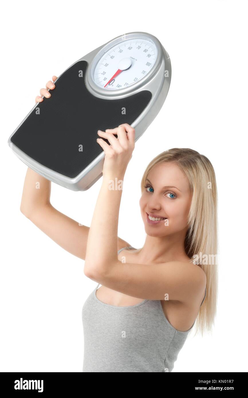 Young woman holding bathroom scale hi-res stock photography and images ...