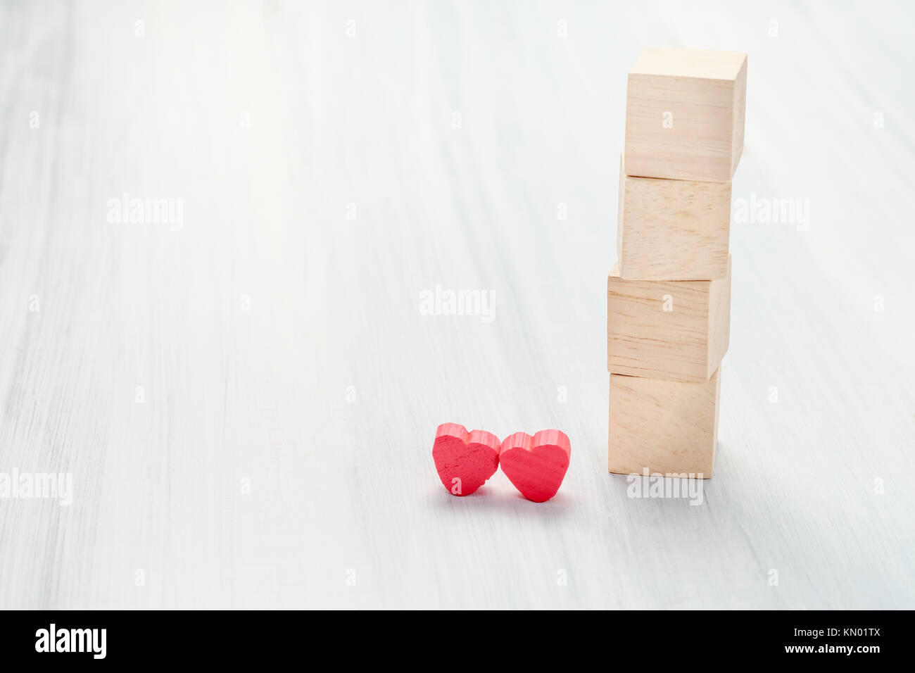 Stack of blank wood cube with couple red heart on white rustic table ...