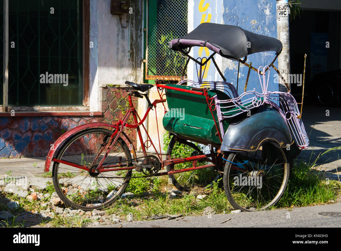 Cycle rickshaw parked at side of road, Yogyakarter, Indonesia Stock ...