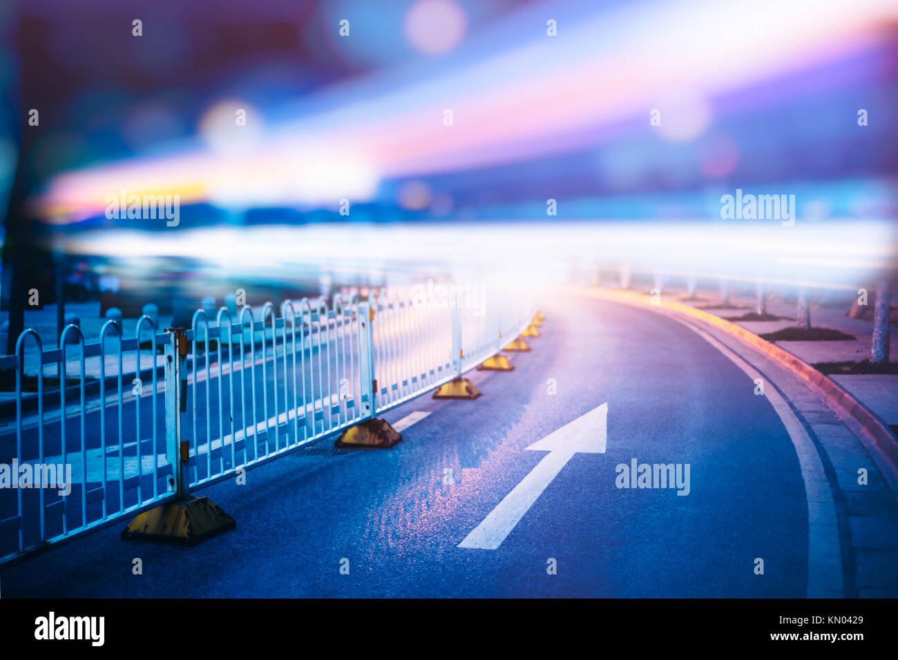 blurred traffic lights on road in central district at night Stock Photo ...