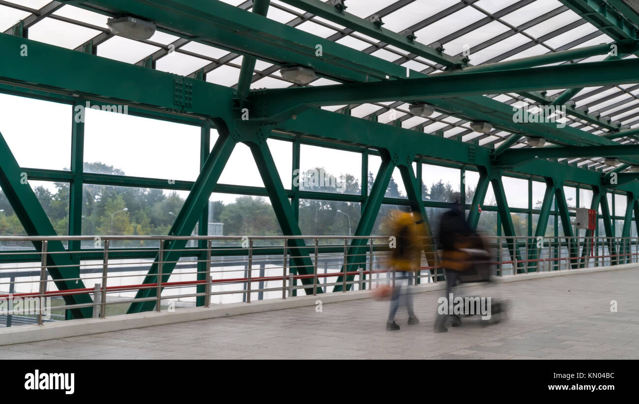 pedestrian motion along transparent bridge Stock Photo - Alamy