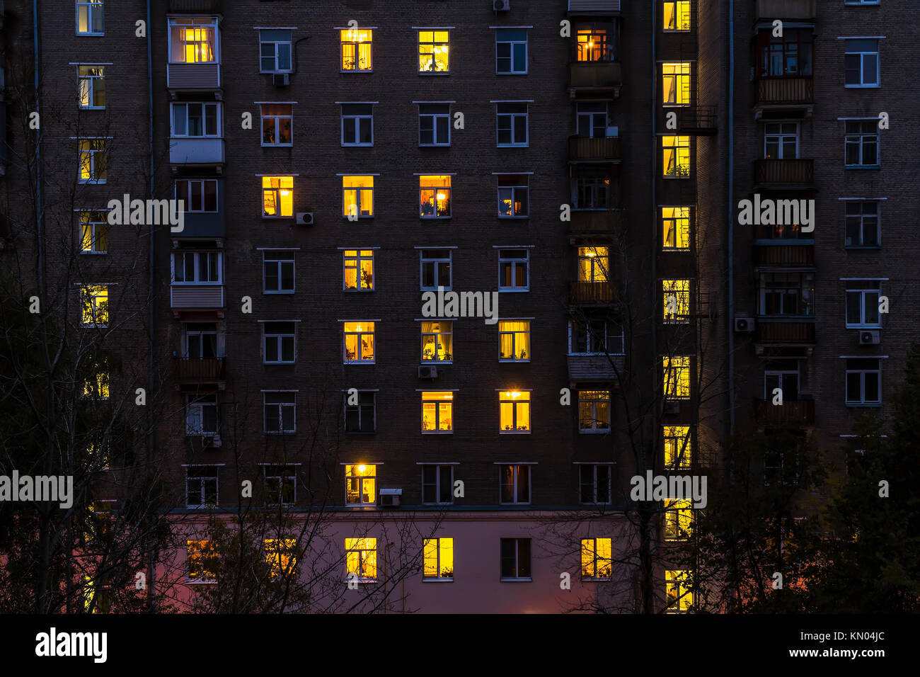Illuminated windows of dwelling house Stock Photo - Alamy