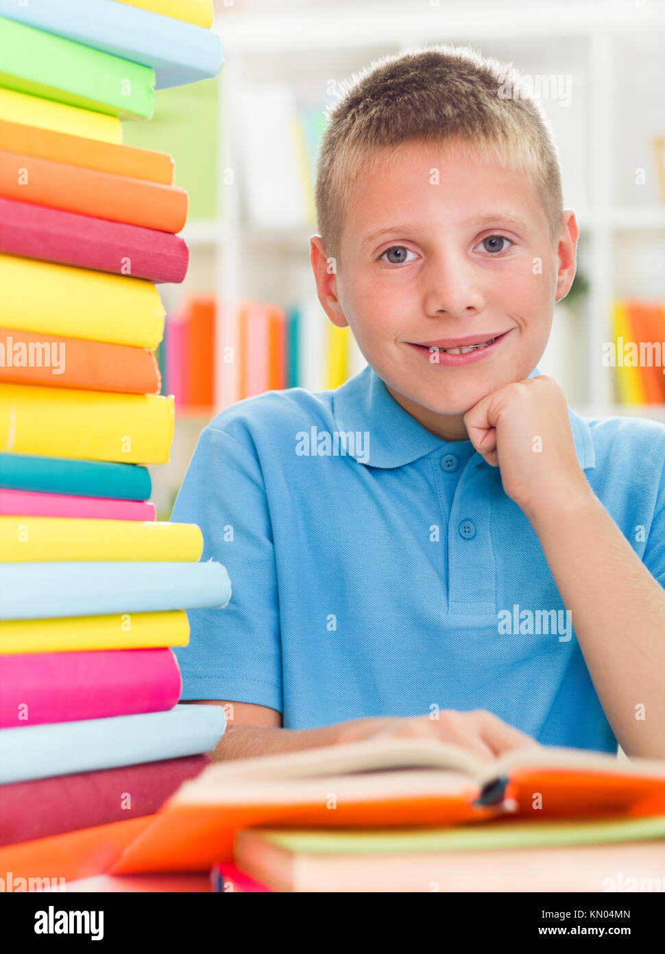 Happy smiling boy studying in order to get good marks Stock Photo - Alamy
