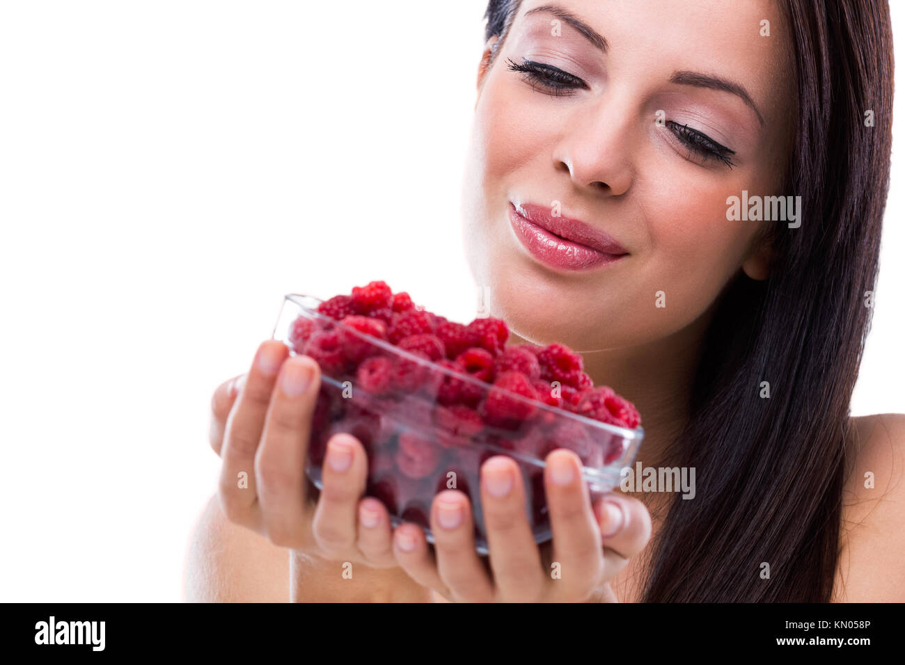 Beautiful woman holding a pot of raspberries Stock Photo - Alamy