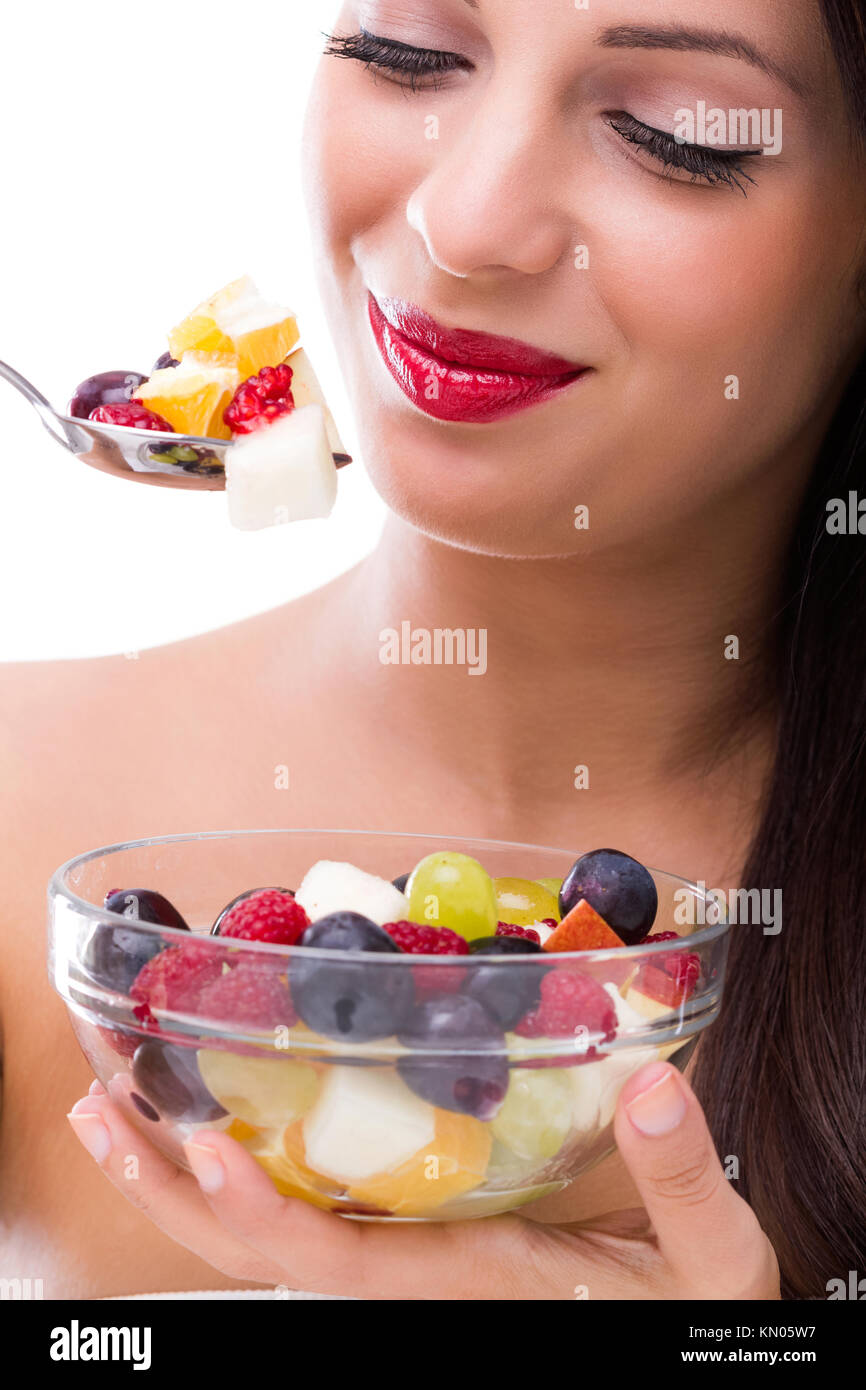 Beautiful young woman eating fresh fruit salad Stock Photo - Alamy
