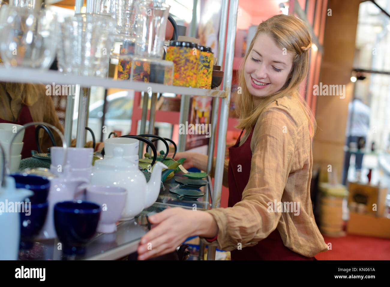 cheerful young female tea store seller Stock Photo - Alamy