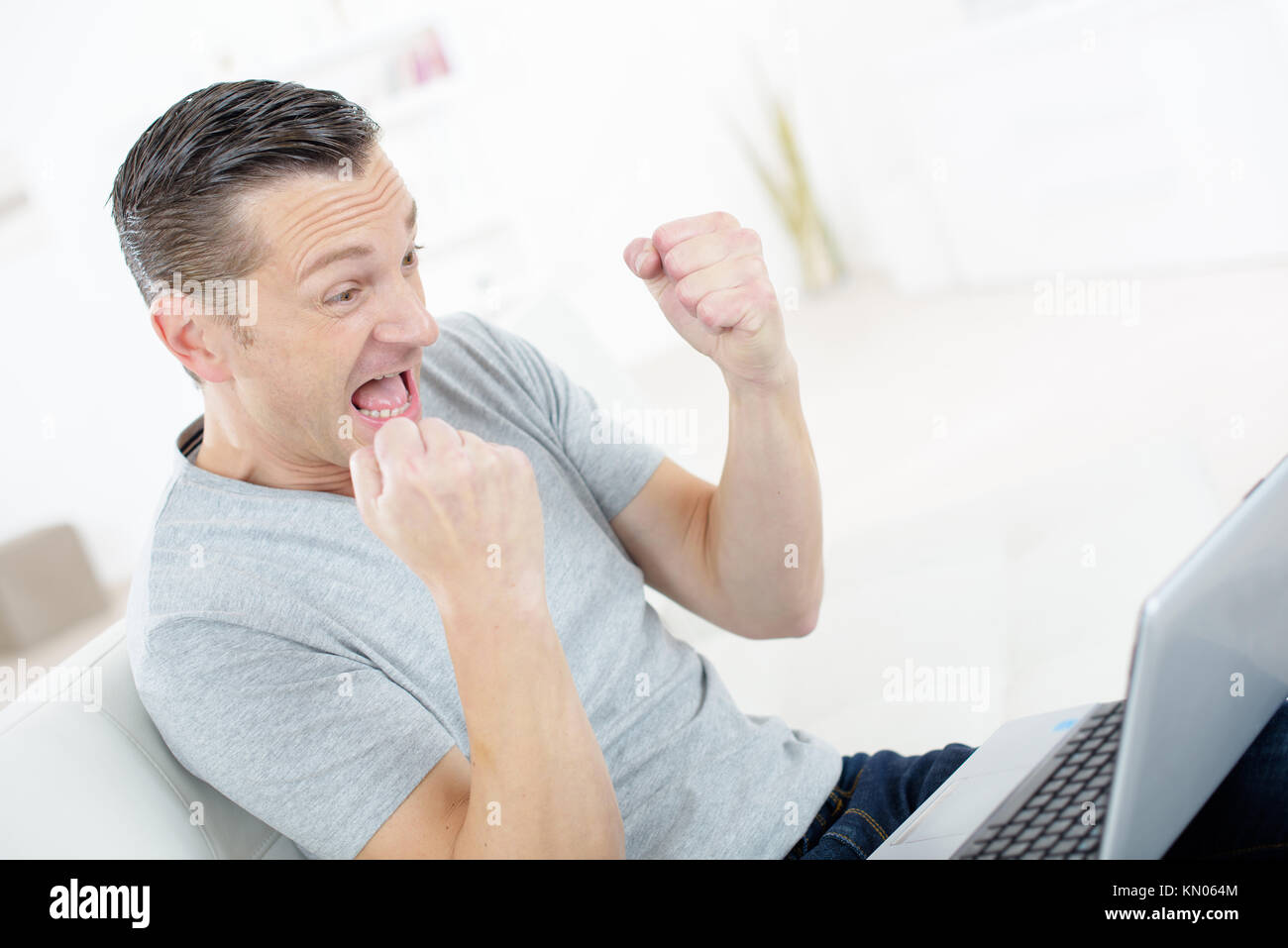 happy man working with laptop in office Stock Photo - Alamy
