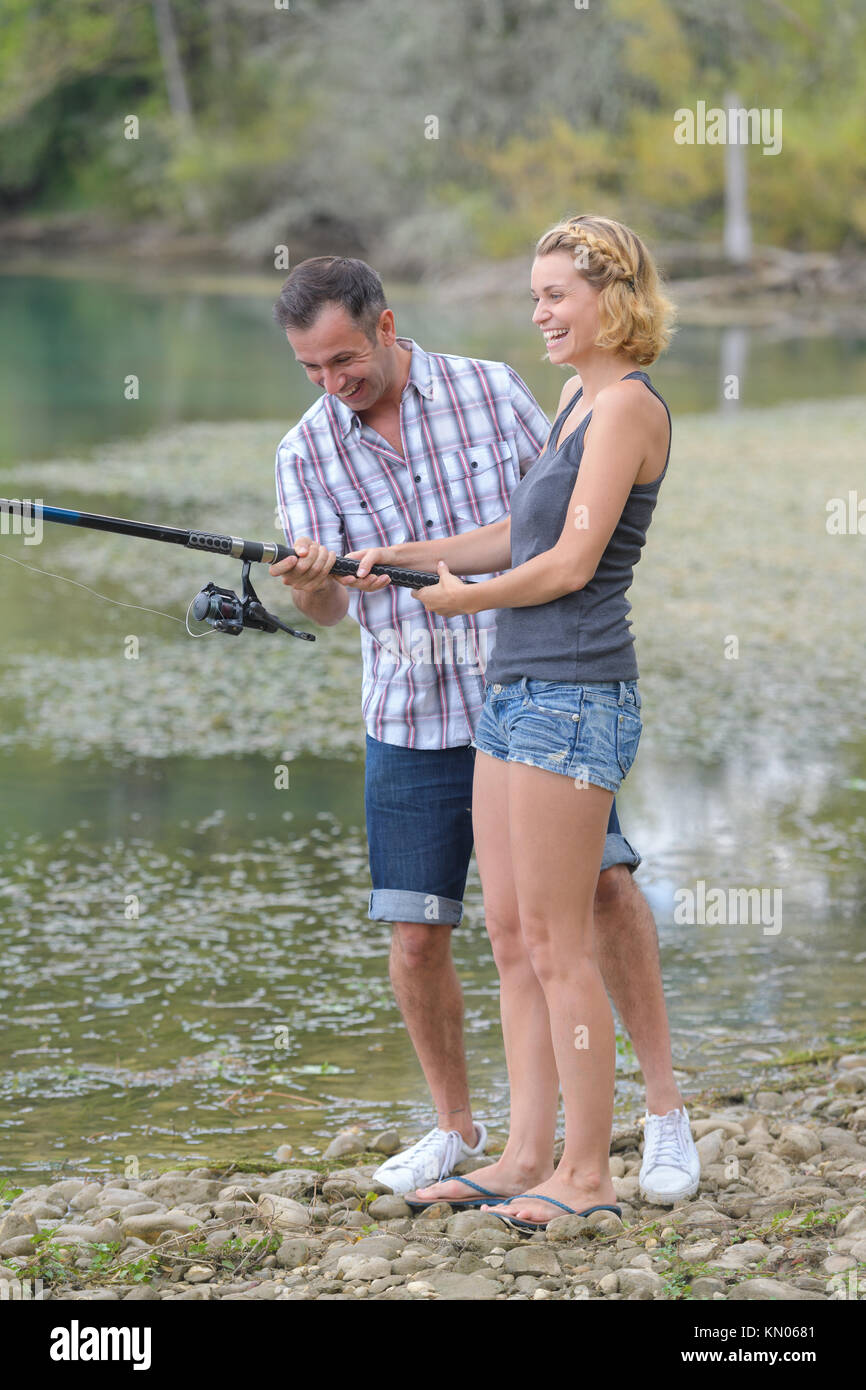 couple catching a fish Stock Photo - Alamy