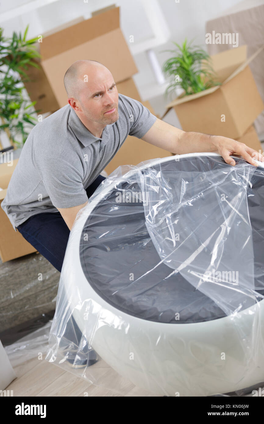 male mover carrying sofa Stock Photo - Alamy