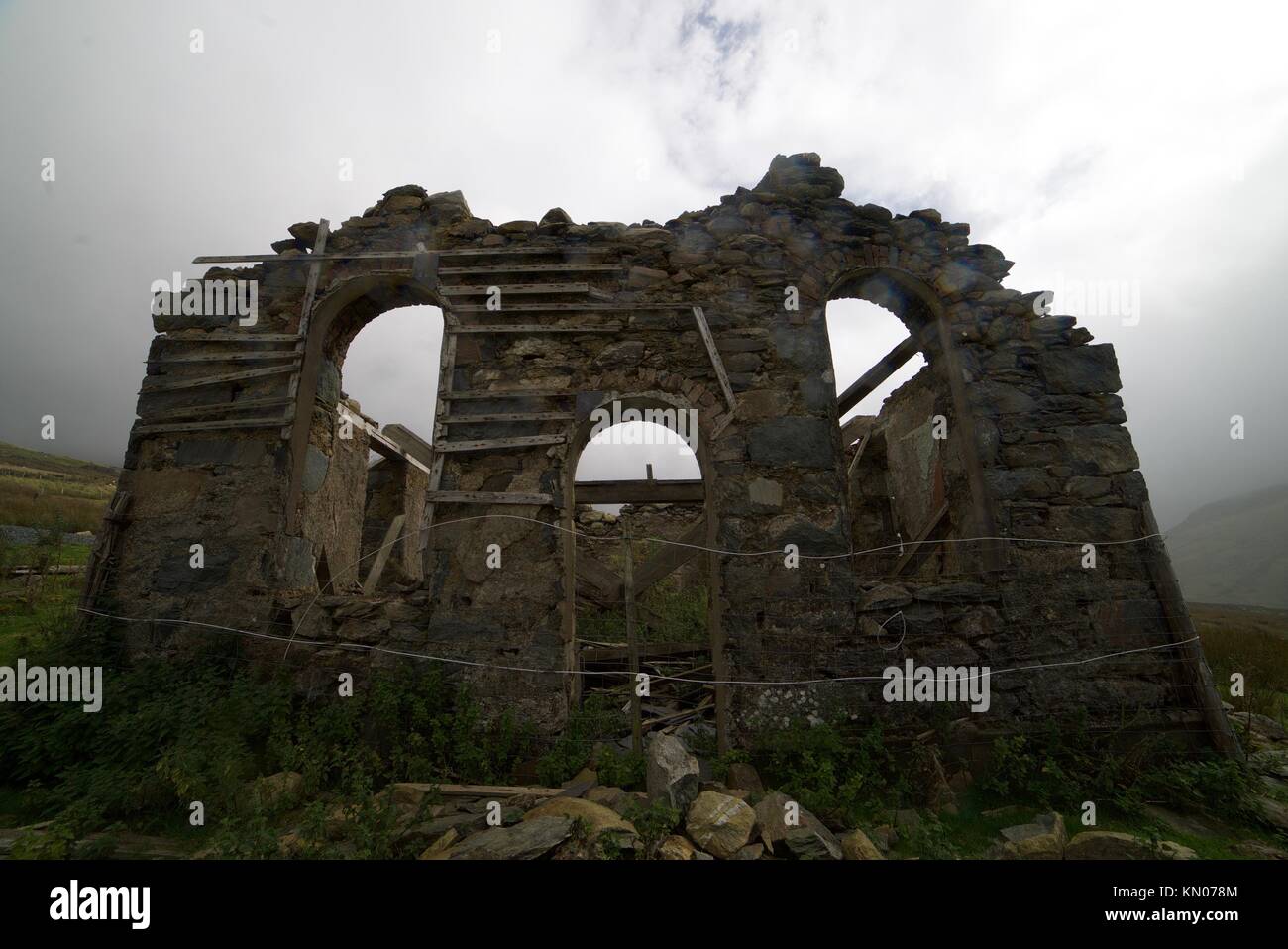 The old stone ruins of a building left abandoned in Snowdonia National ...