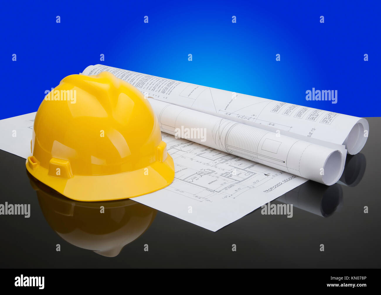 Construction site safety gear and tools with blueprints Stock Photo - Alamy