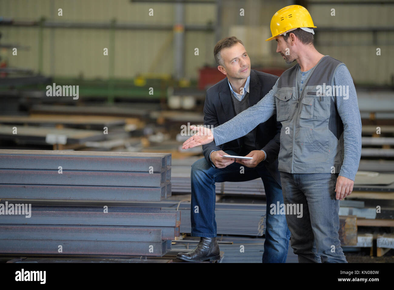 supervisor and production worker talking Stock Photo - Alamy
