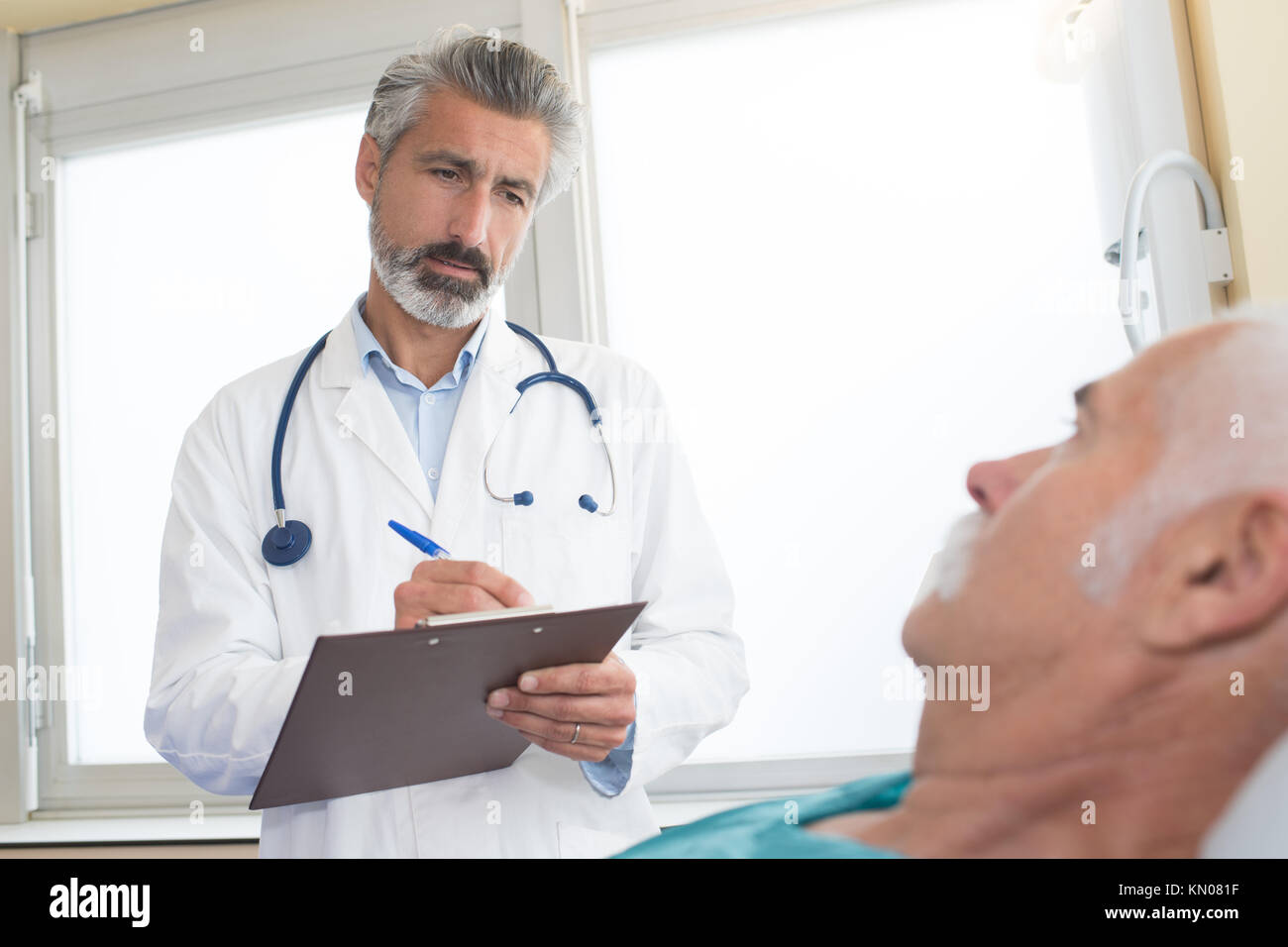 Old man visiting doctor hi-res stock photography and images - Alamy