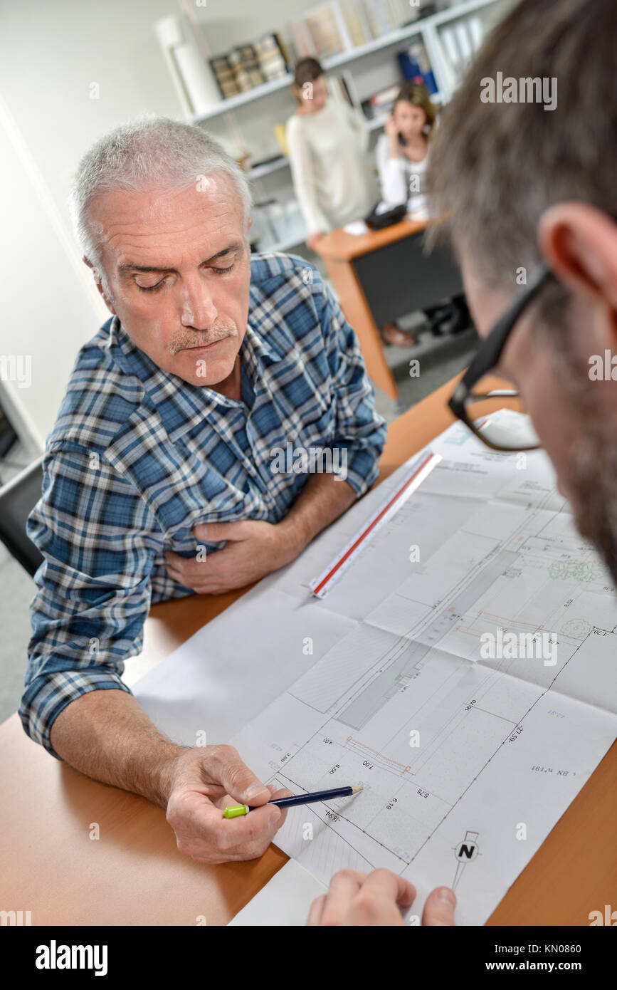 Architect explaining something to client Stock Photo - Alamy