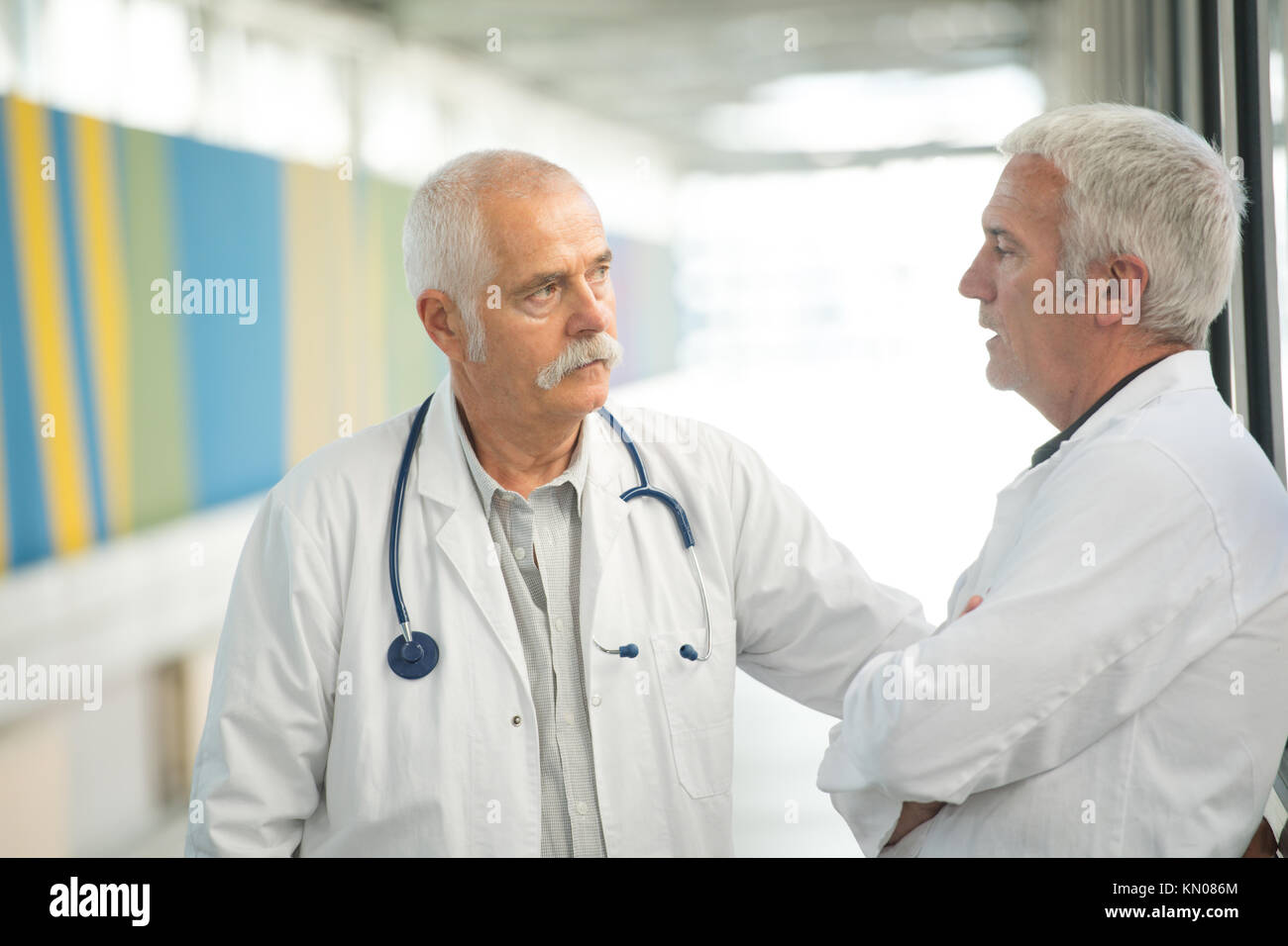 Doctors talking in hospital corridor hi-res stock photography and ...