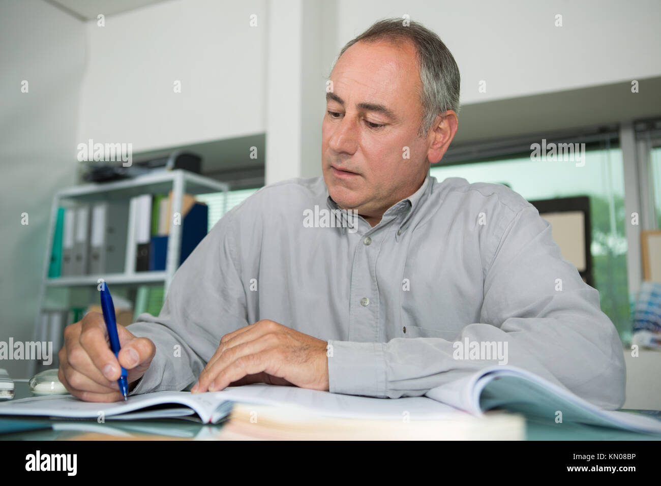 man working at a workplace Stock Photo - Alamy
