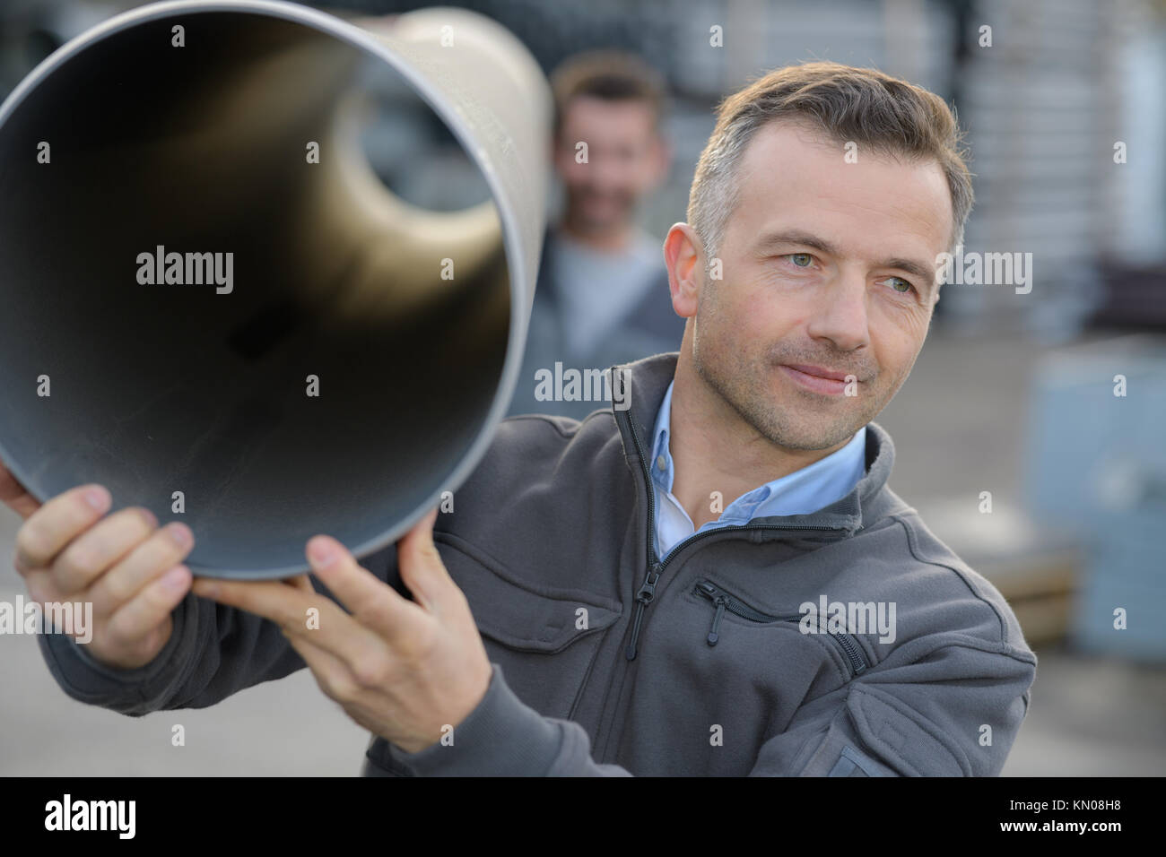 Construction worker carrying pipes hi-res stock photography and images ...