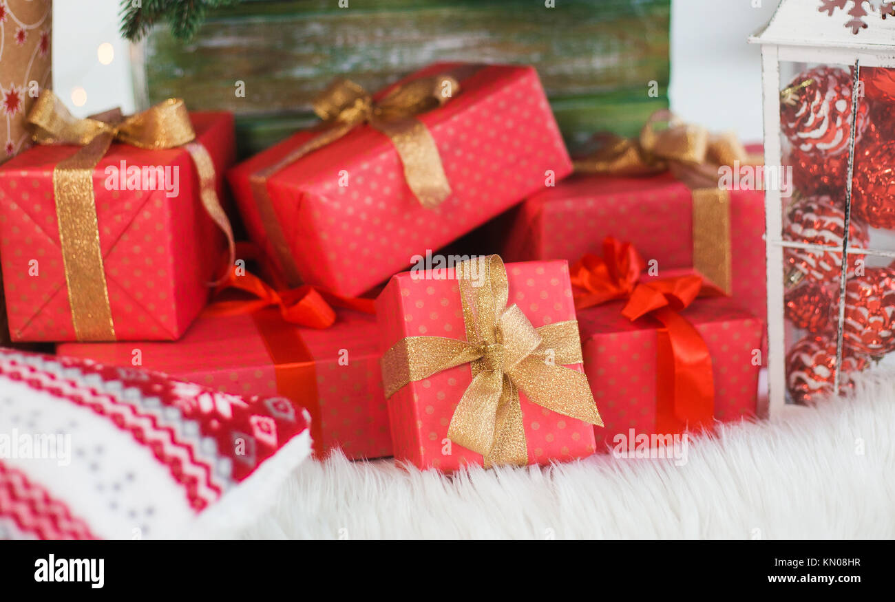 Closeup view of many boxes wrapped in red festive wrapping paper ...