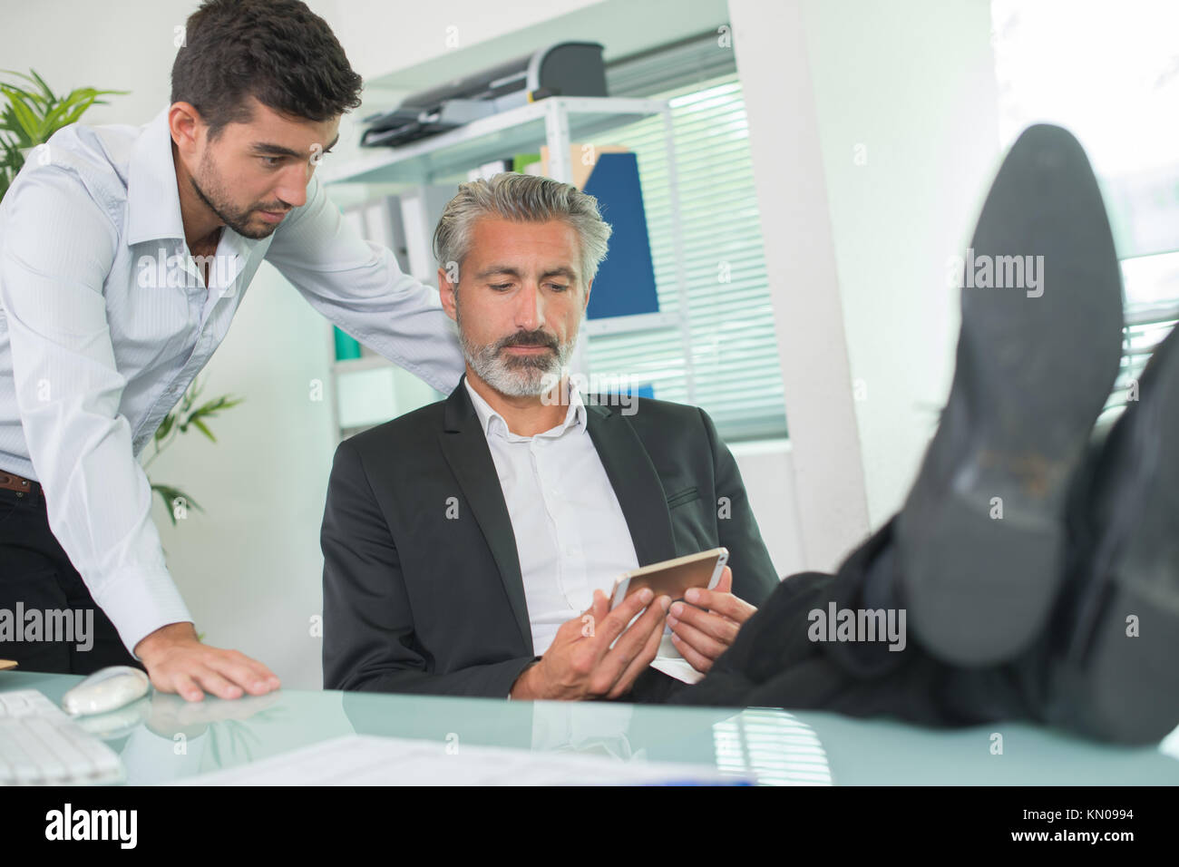 boss and assistant in the office Stock Photo - Alamy