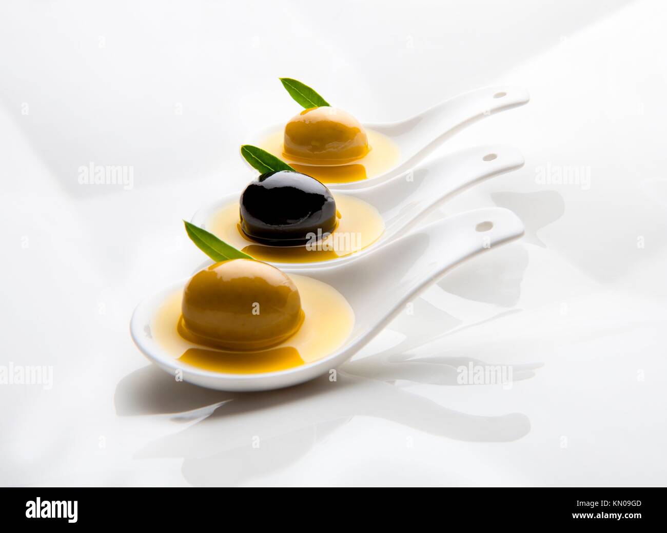 three tablespoons olive tasting with three Stock Photo - Alamy