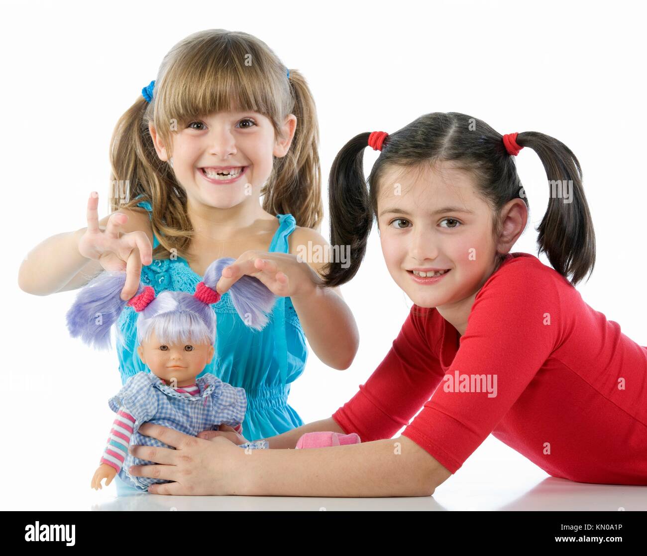 Two children with their favorite dolls Stock Photo - Alamy