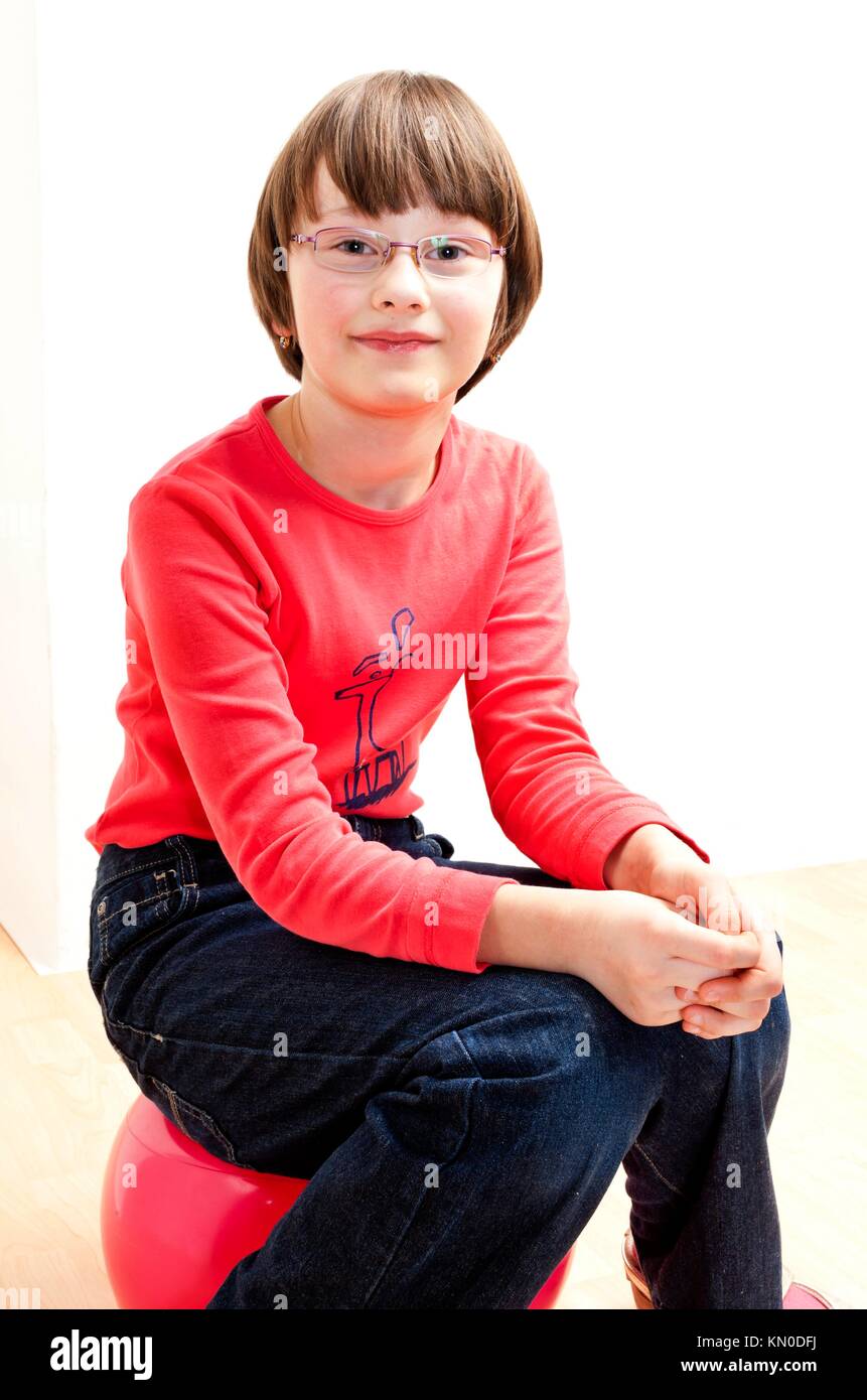 portrait of girl sitting on a ball Stock Photo - Alamy