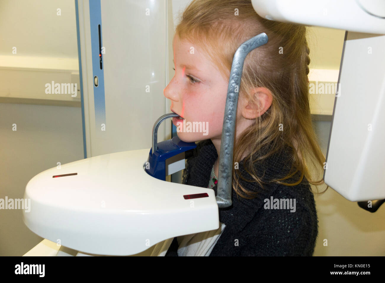 Child aged seven years in position to have a dental x-ray scan, by a ...
