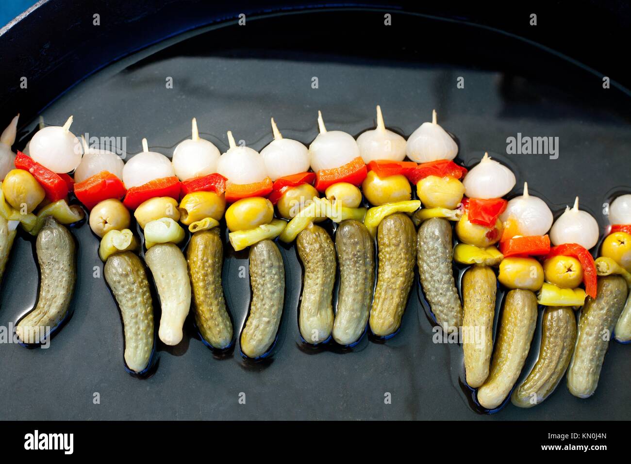 hot spicy appetizer in stick with pickles olives chili pepper and onion ...