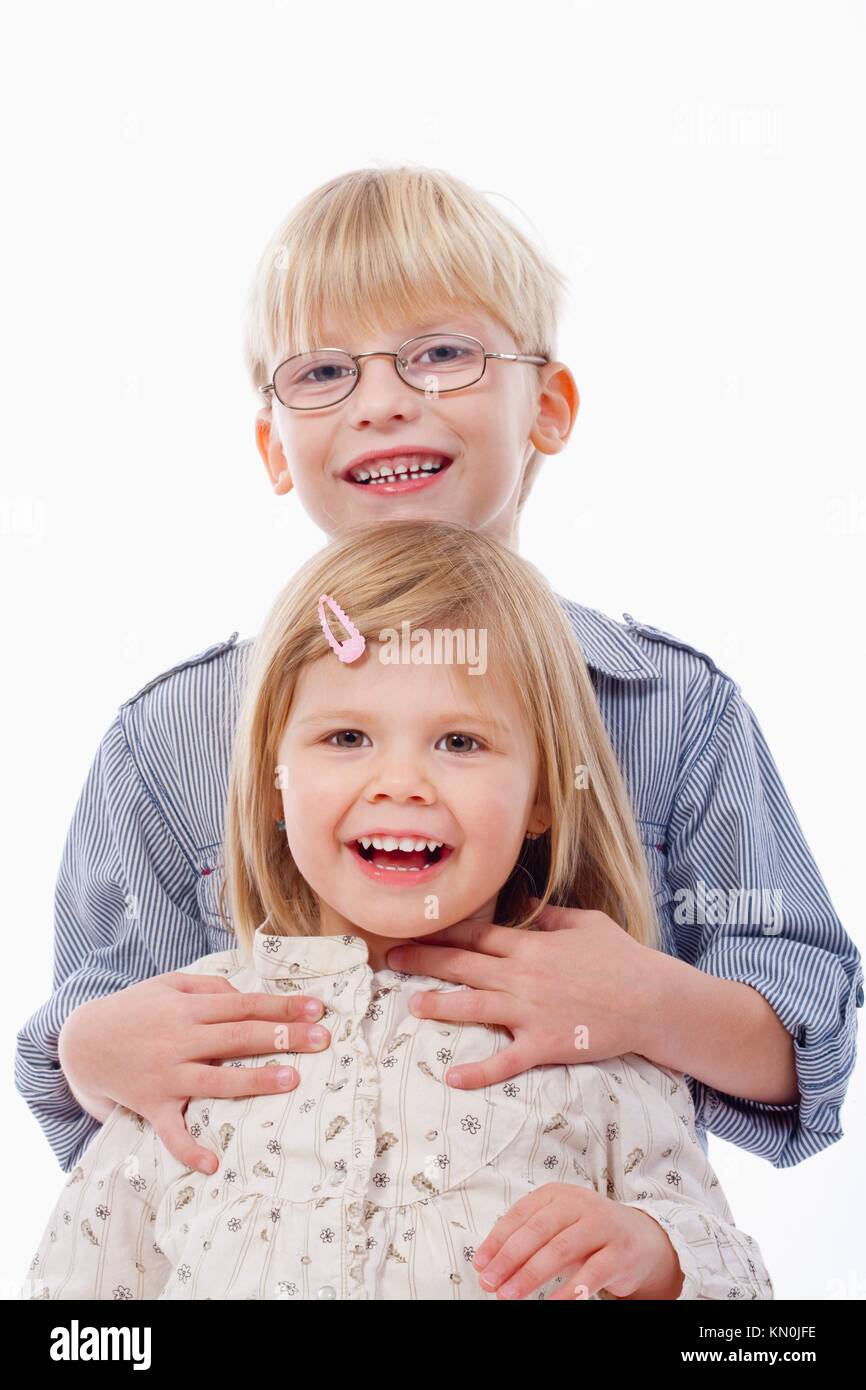 portrait of two young siblings looking at camera, smiling - isolated on ...