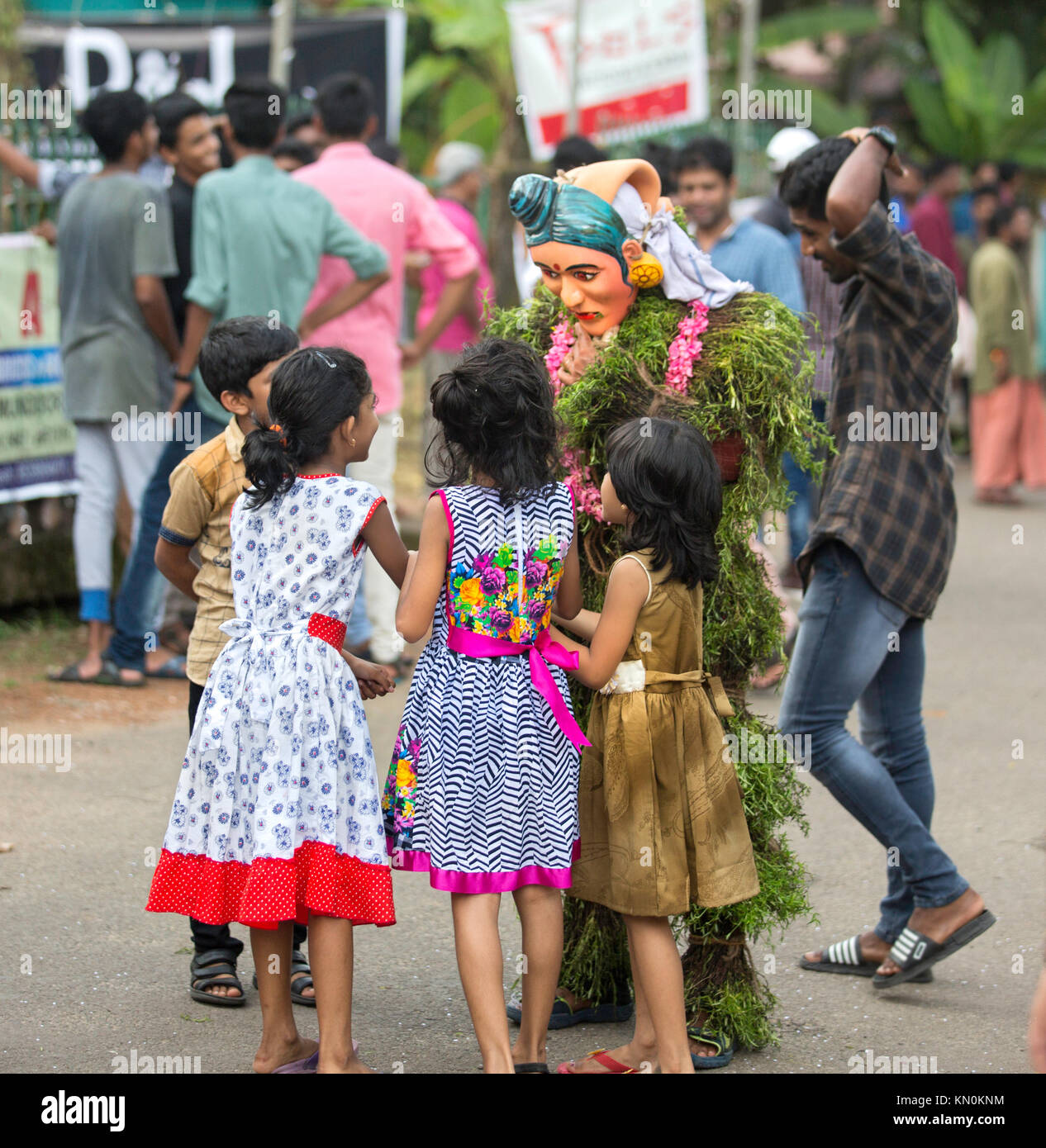 traditional kummatti folk dance performer with a children during onam ...