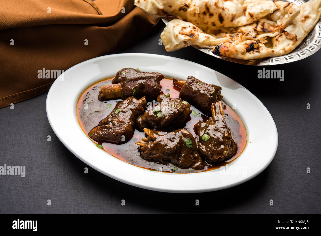 lamb shank or mutton or gosht paya or khoor curry served with indian ...